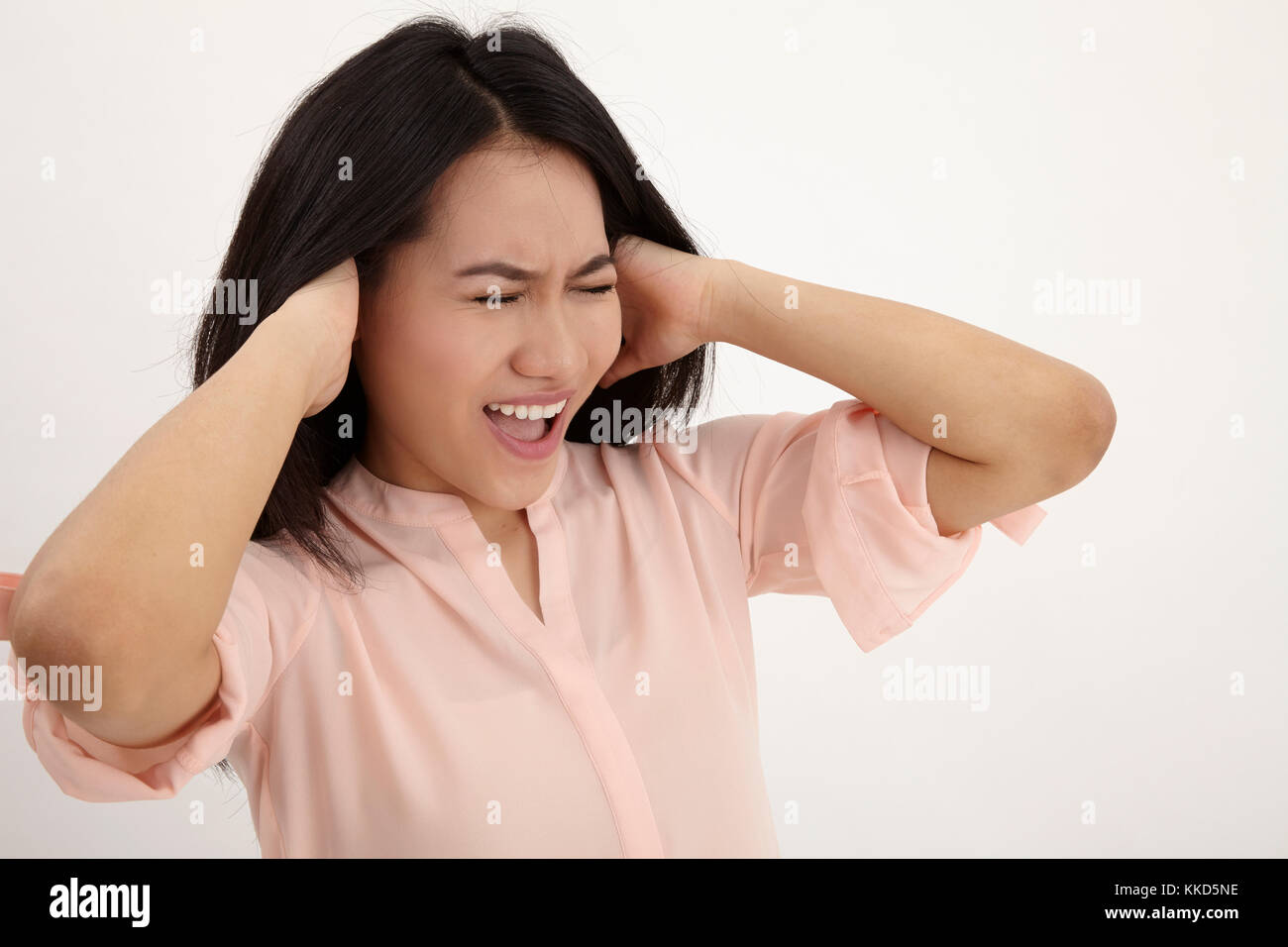 malay woman closed her ear shouting Stock Photo - Alamy