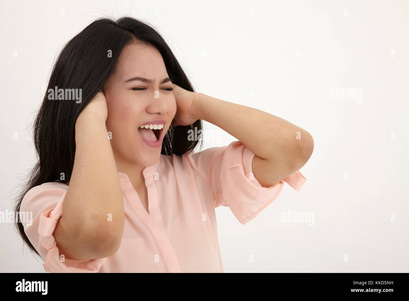 malay woman closed her ear shouting Stock Photo - Alamy