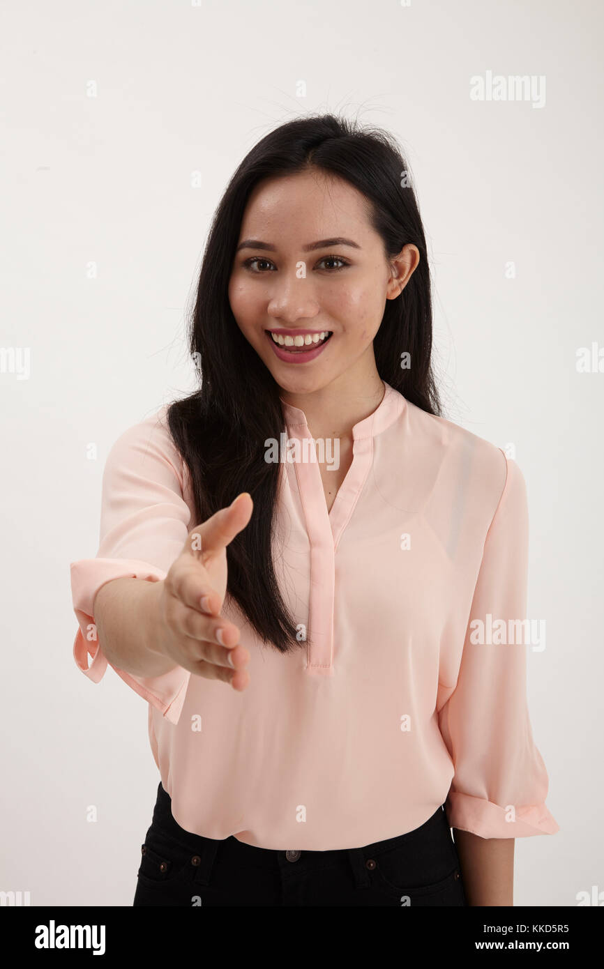 malay woman raising arm about to do hand shake Stock Photo - Alamy