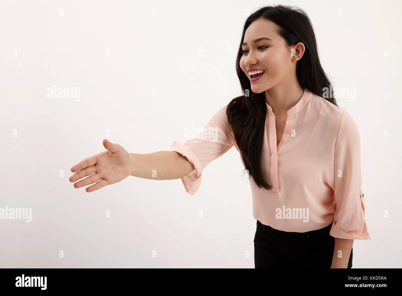 malay woman raising arm about to do hand shake Stock Photo - Alamy