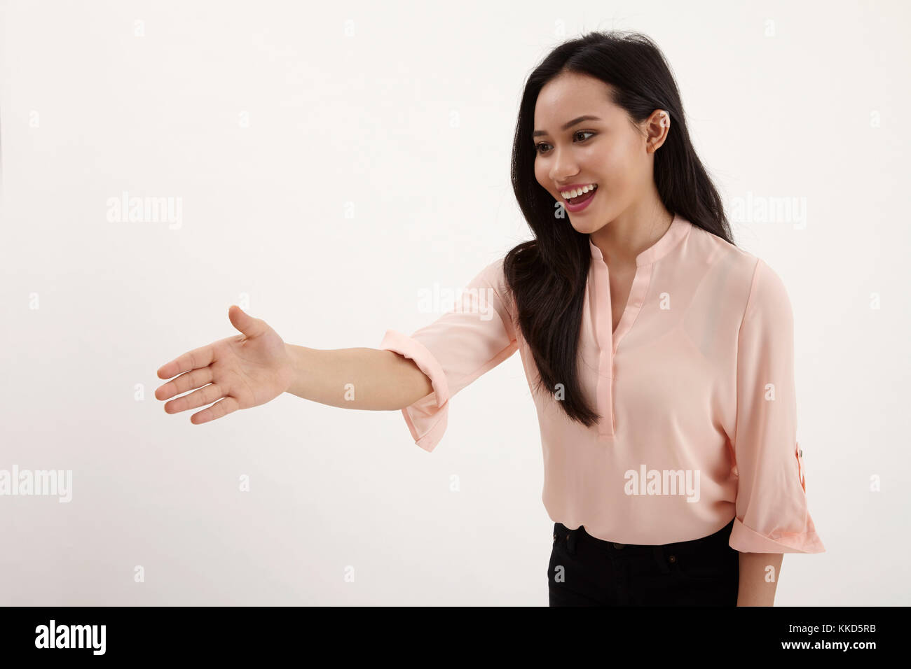 malay woman raising arm about to do hand shake Stock Photo - Alamy