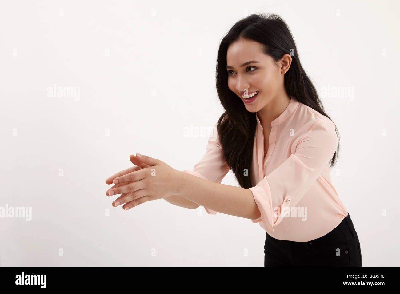 malay woman raising arm about to do hand shake Stock Photo - Alamy
