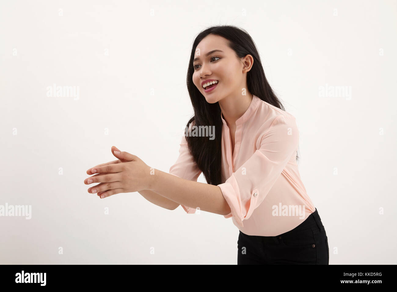 malay woman raising arm about to do hand shake Stock Photo - Alamy