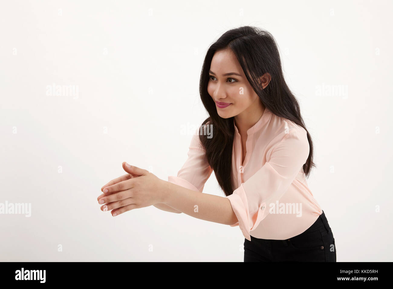 malay woman raising arm about to do hand shake Stock Photo - Alamy