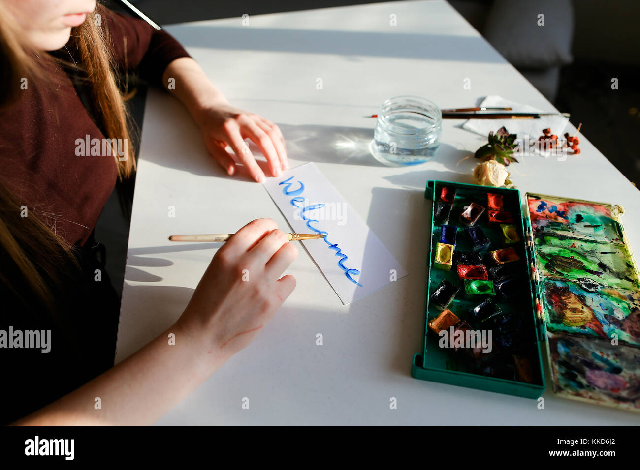 Young woman painter writes watercolor writing on paper, sitting Stock ...