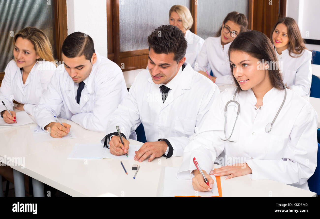 Smiling multinational students and professor having discussion at ...