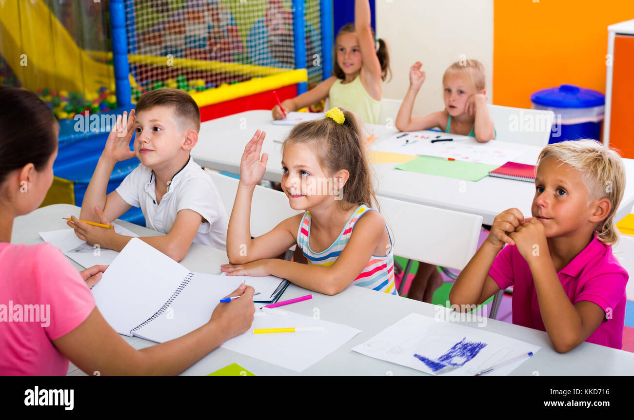 little american children sitting together and studying in class at ...