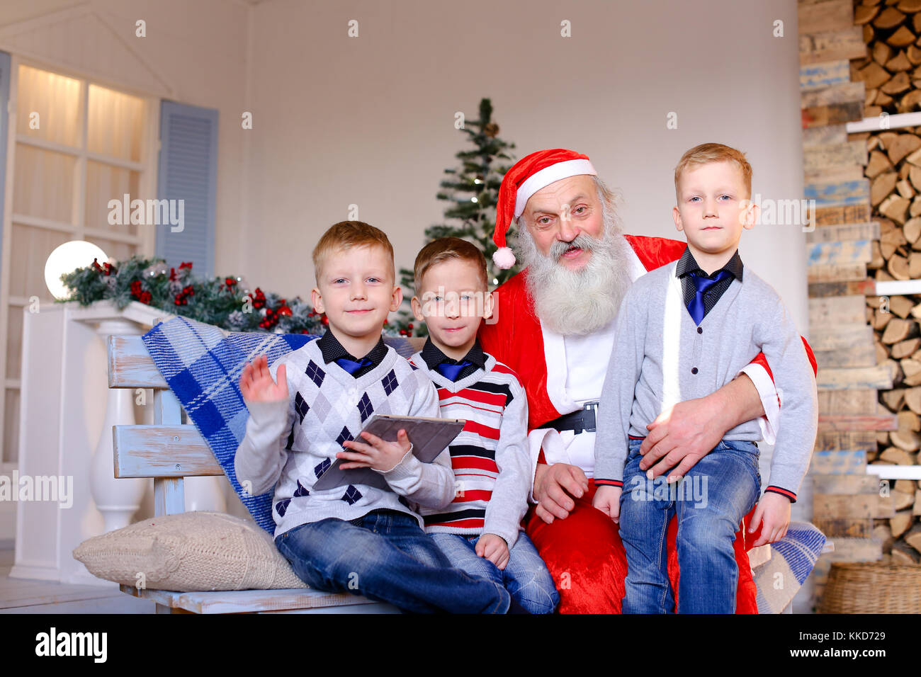 Father enjoys kids playing role of Santa Claus Stock Photo - Alamy