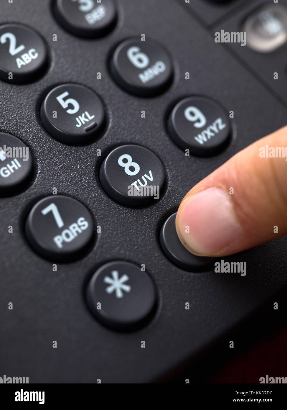 close up shot of a thumb pressing number on landline phone Stock Photo ...