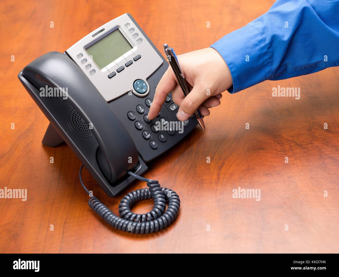 hand dialing number on landline phone Stock Photo - Alamy