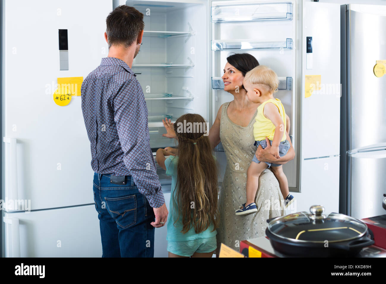 smiling family of four choosing new fridge in household store Stock ...