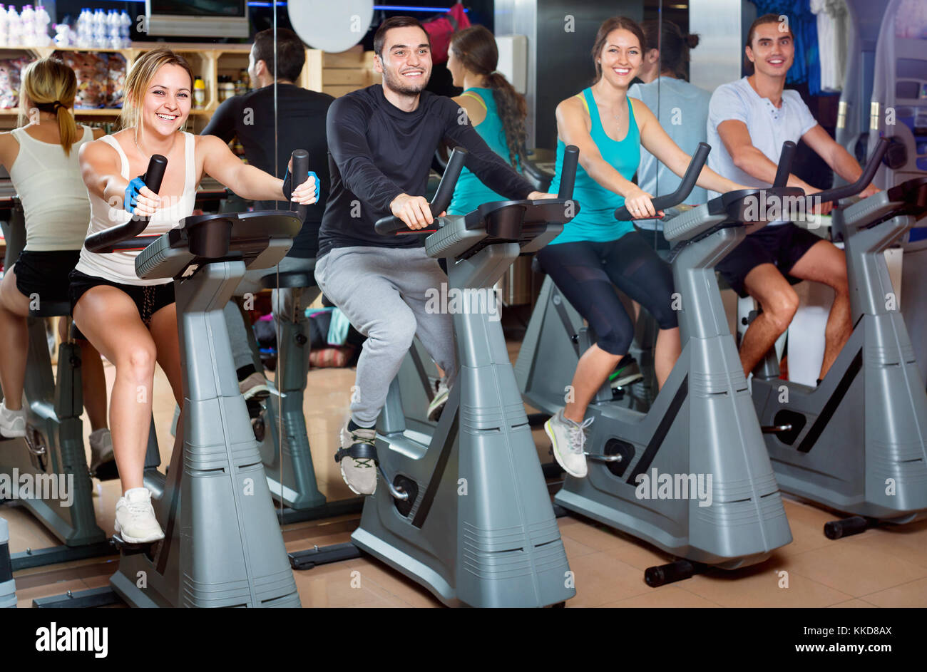 Group positive happy working out of cycling in modern fitness club ...