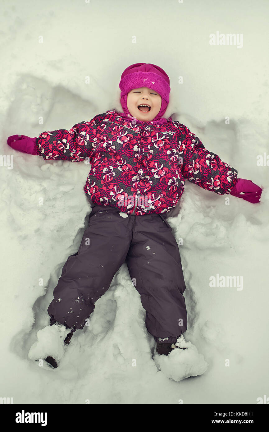 little girl making snow angel Stock Photo - Alamy