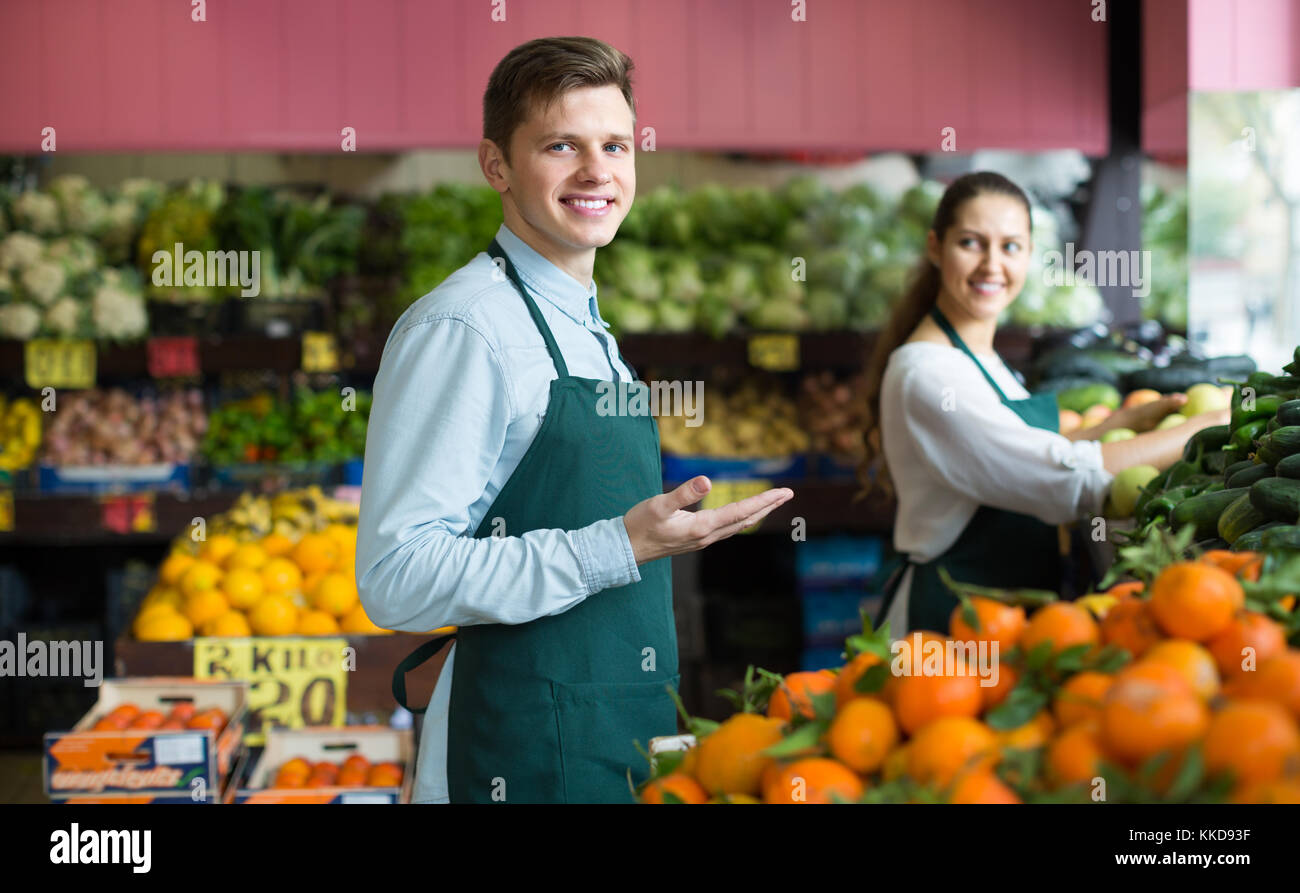 two workers selling fresh fruits and vegetables on market Stock Photo ...