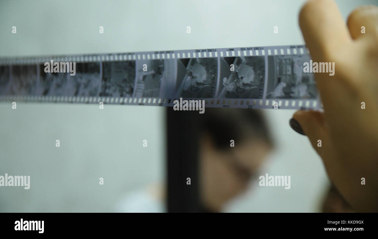 Photographer looking on negative film. Done work inspecting. Old ...