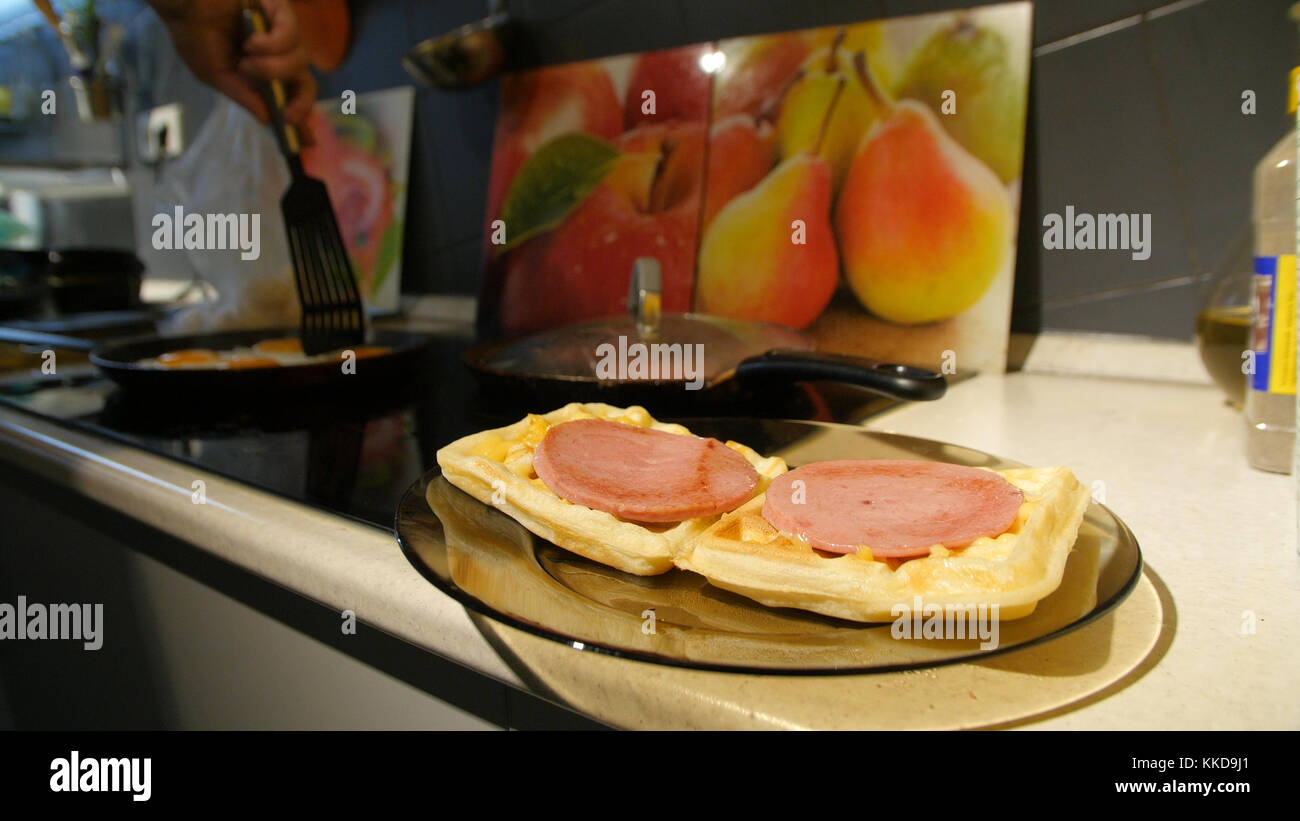 A man cook prepares and salt eggs in a beautiful kitchen. Man in the ...
