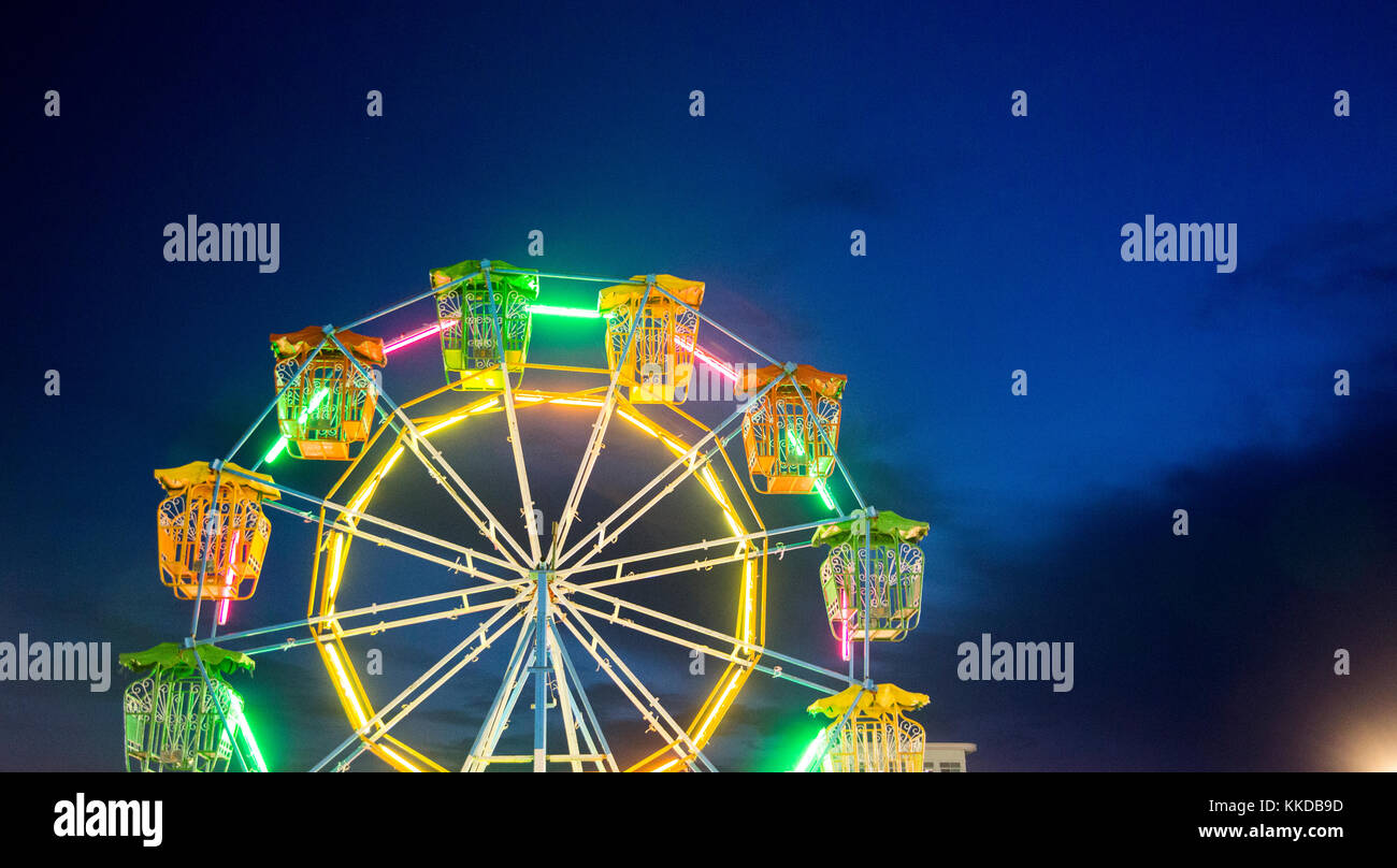 ferris wheel with neon light moving spin at night carnival park Stock ...