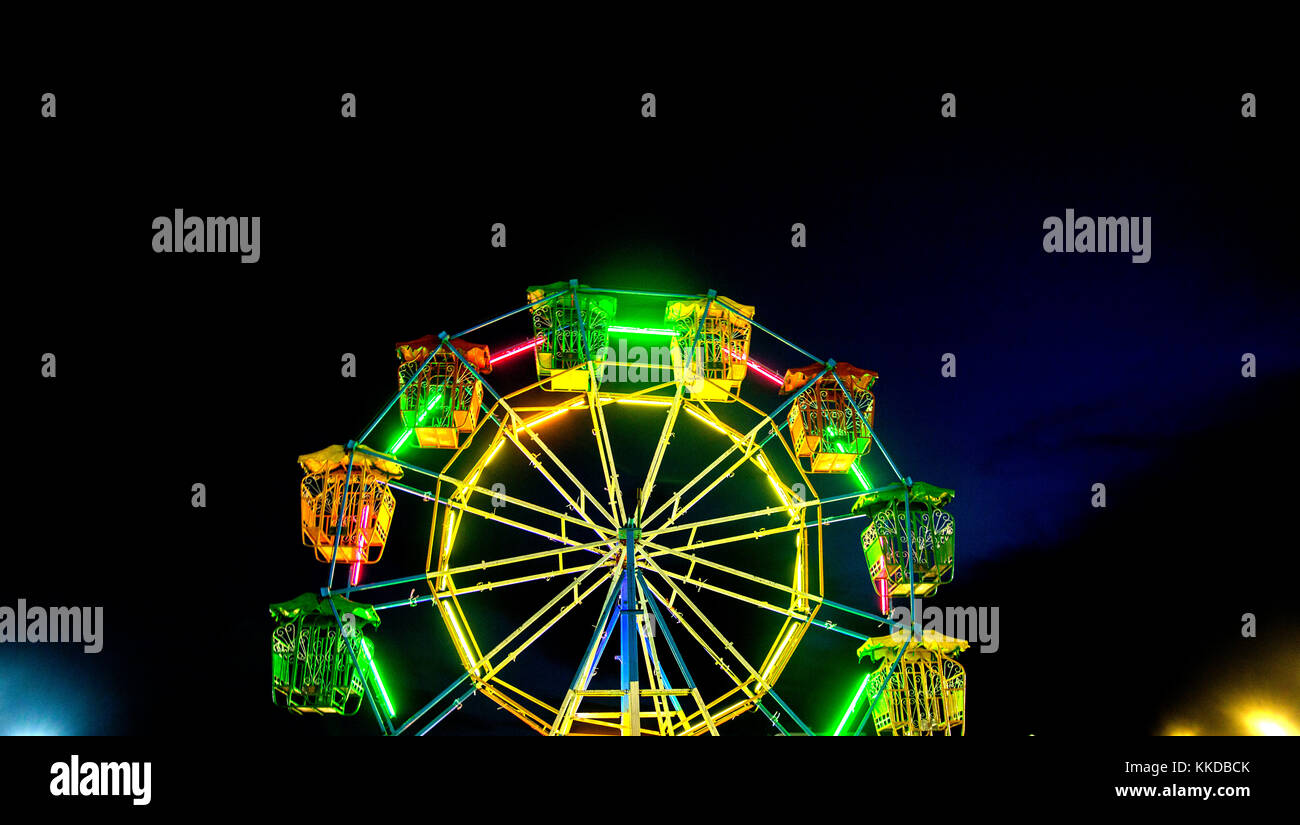close up ferris wheel with neon light at night carnival park Stock ...