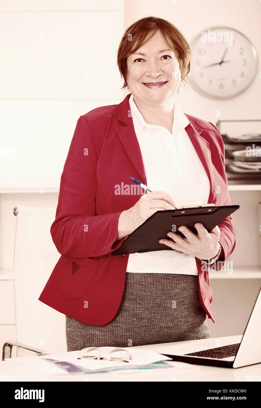 Smiling woman manager waiting for clients in her office Stock Photo - Alamy