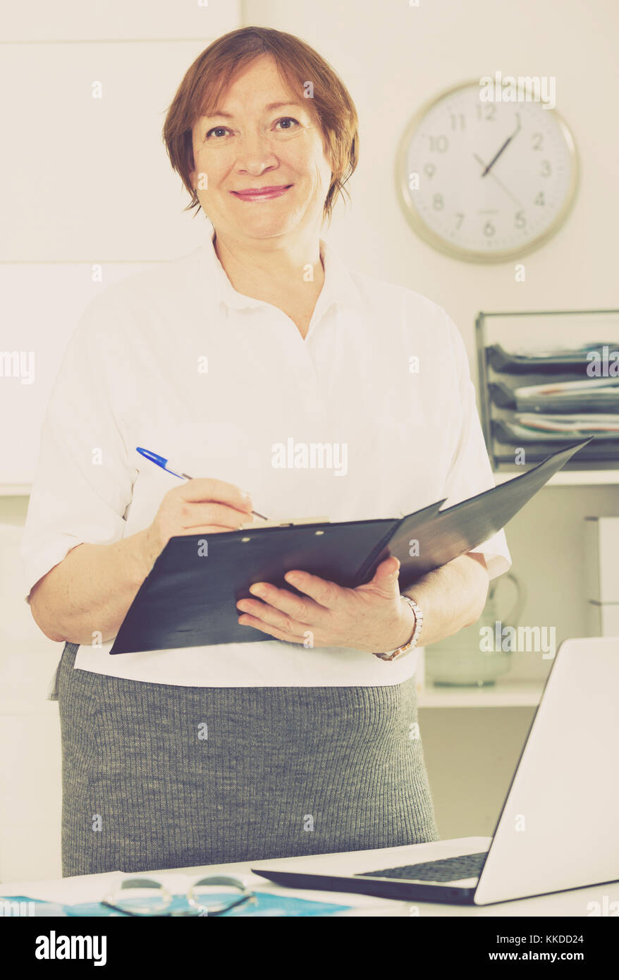 Smiling woman manager waiting for clients in her office Stock Photo - Alamy
