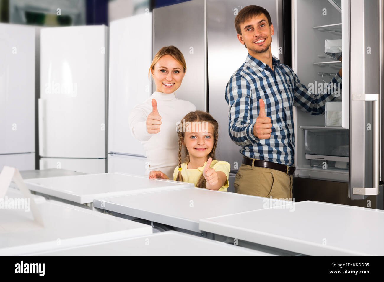 happy family buying refrigerator in appliance shop Stock Photo - Alamy