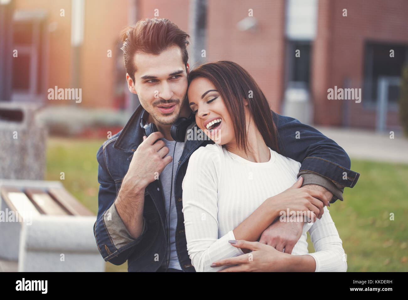 Happy young couple have fun at outdoor, cuddle each other, laughing ...