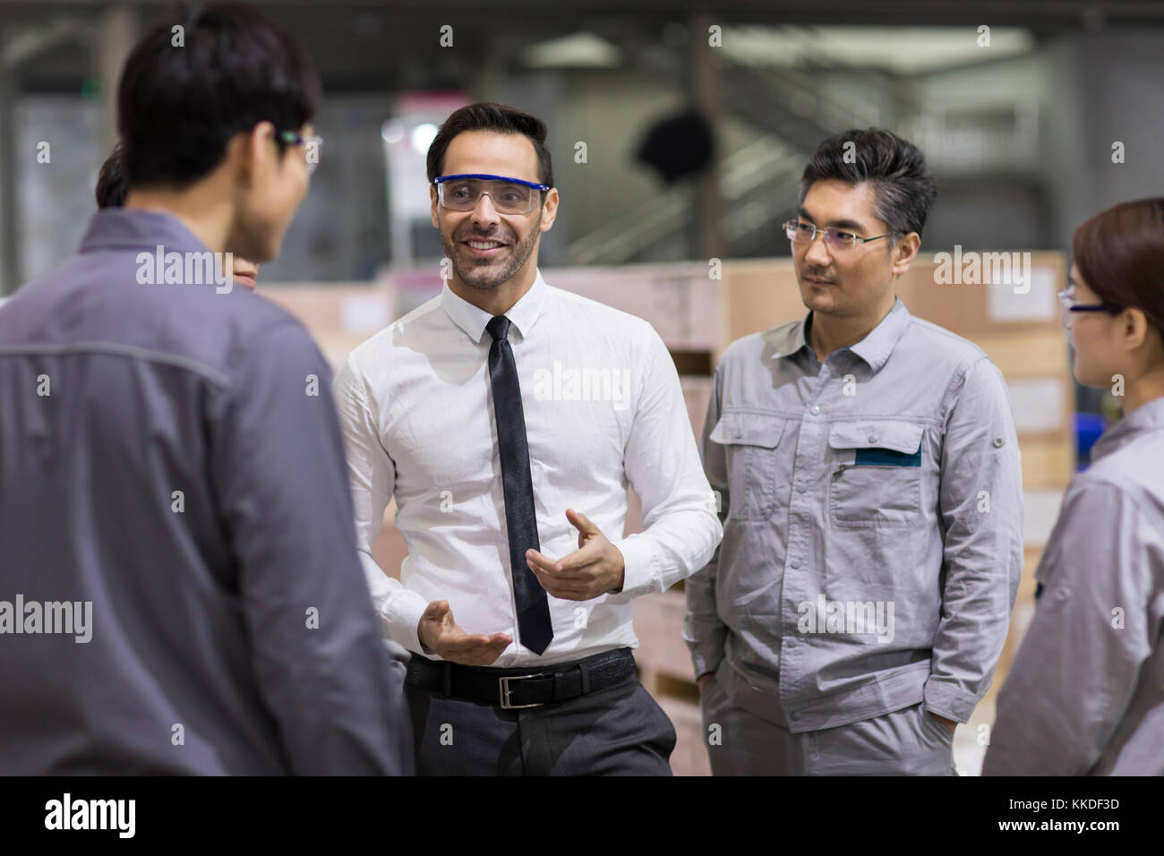 Businessman and engineers talking in the factory Stock Photo - Alamy