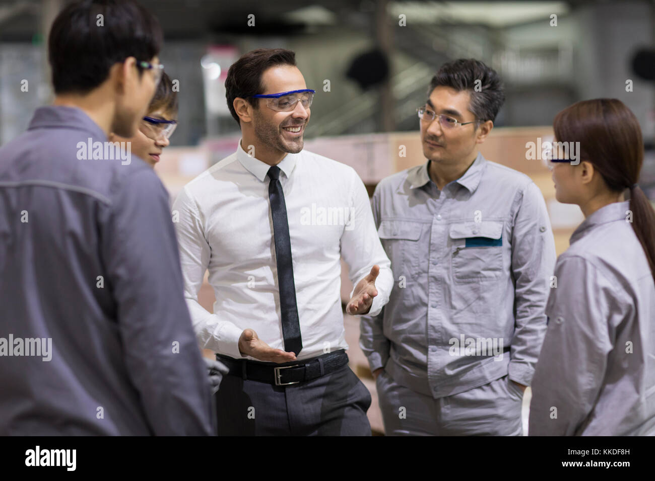 Businessman and engineers talking in the factory Stock Photo - Alamy