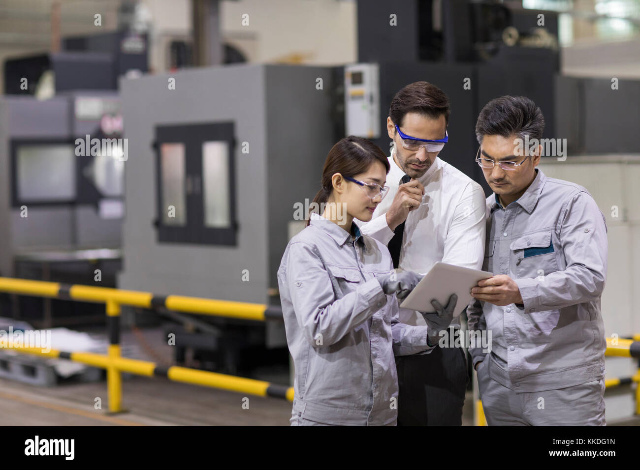 Engineers working digital equipment close hi-res stock photography and ...