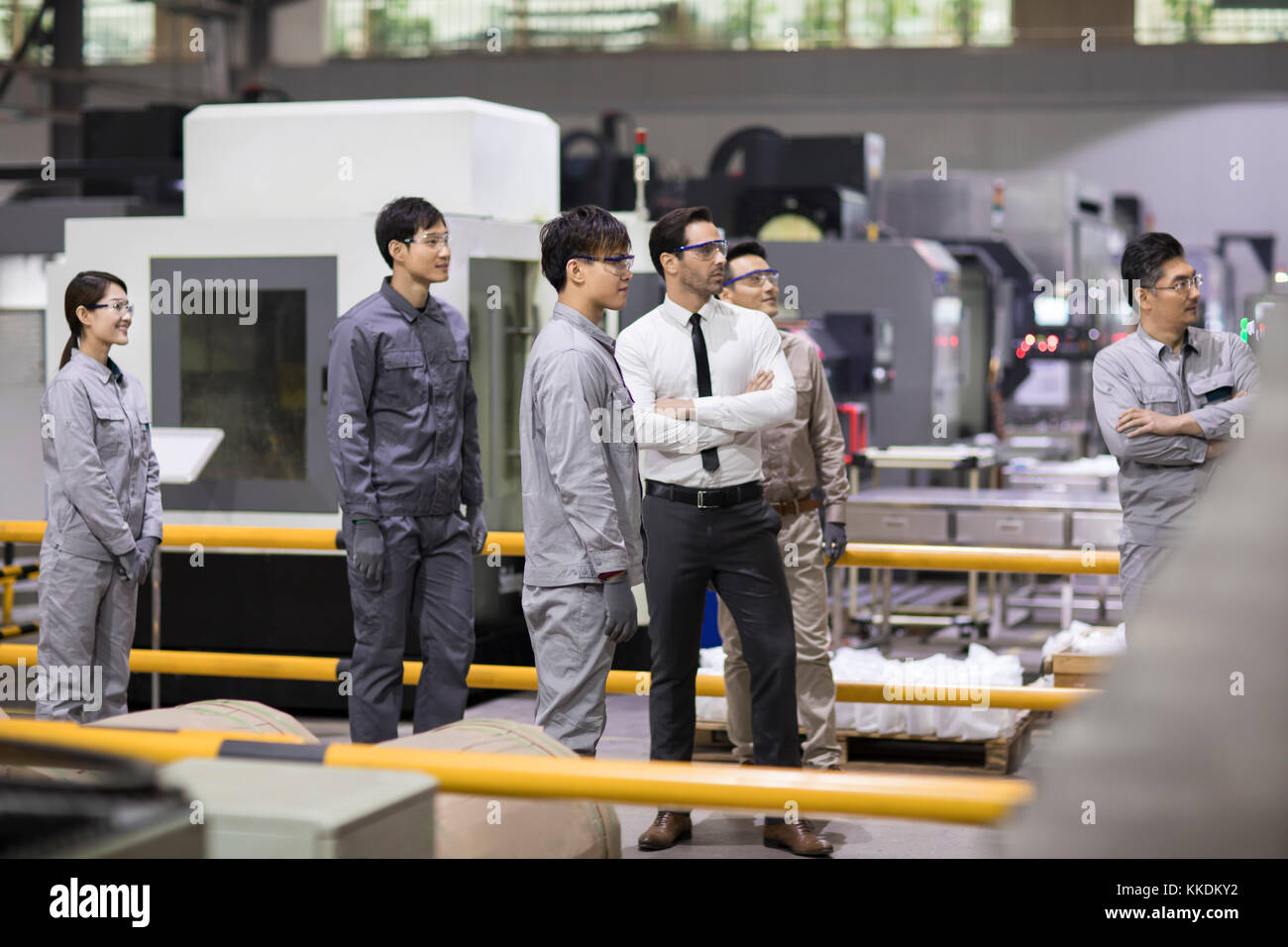 Confident businessman and engineering team in the factory Stock Photo ...