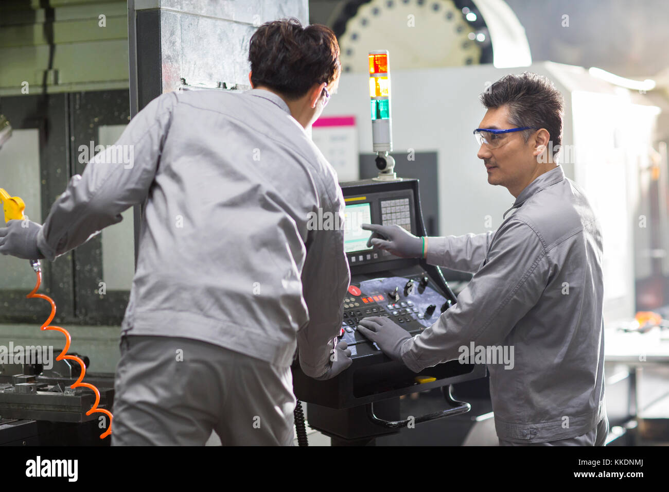 Confident Chinese engineers working in the factory Stock Photo - Alamy