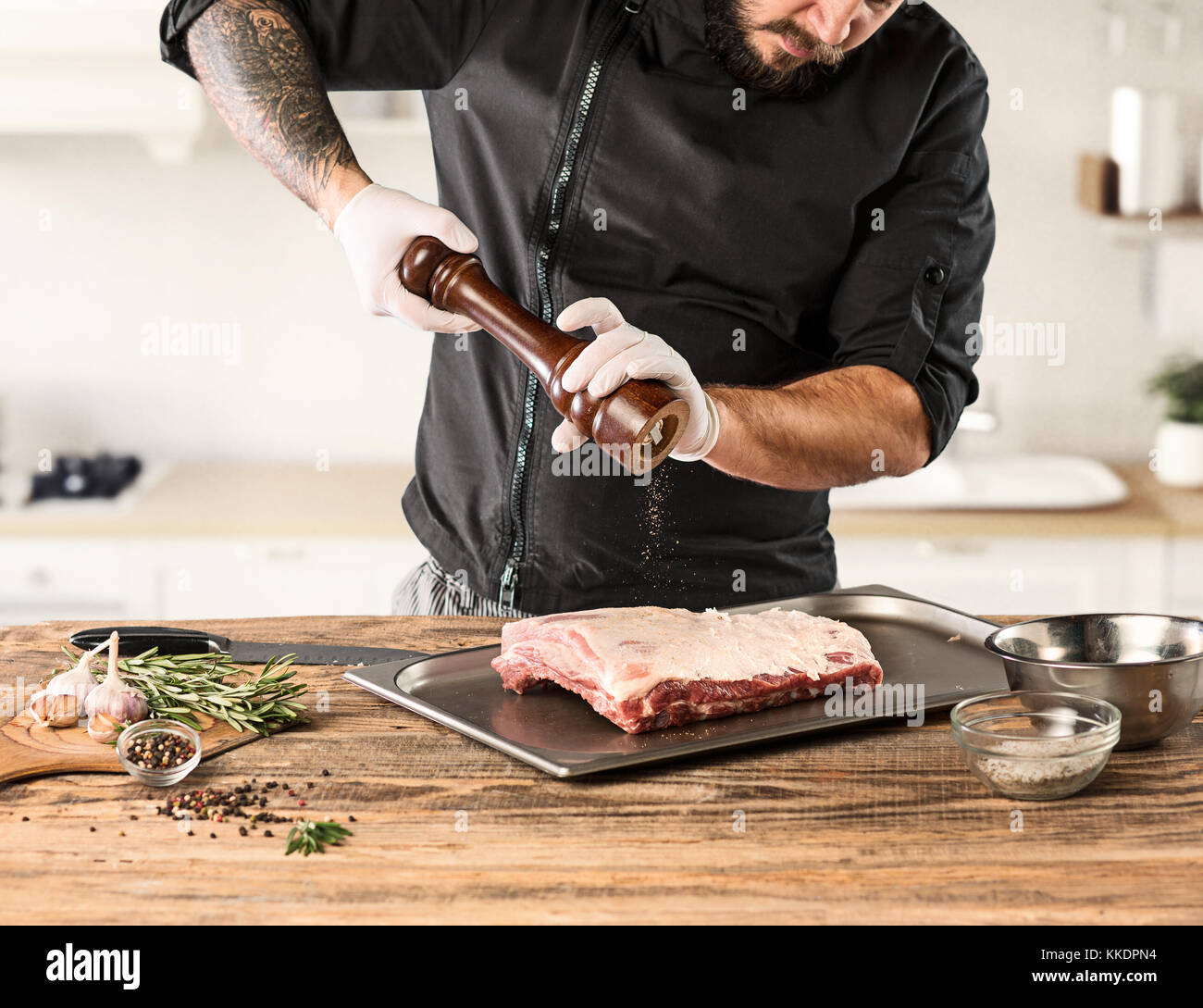 Man cooking meat steak on kitchen Stock Photo - Alamy