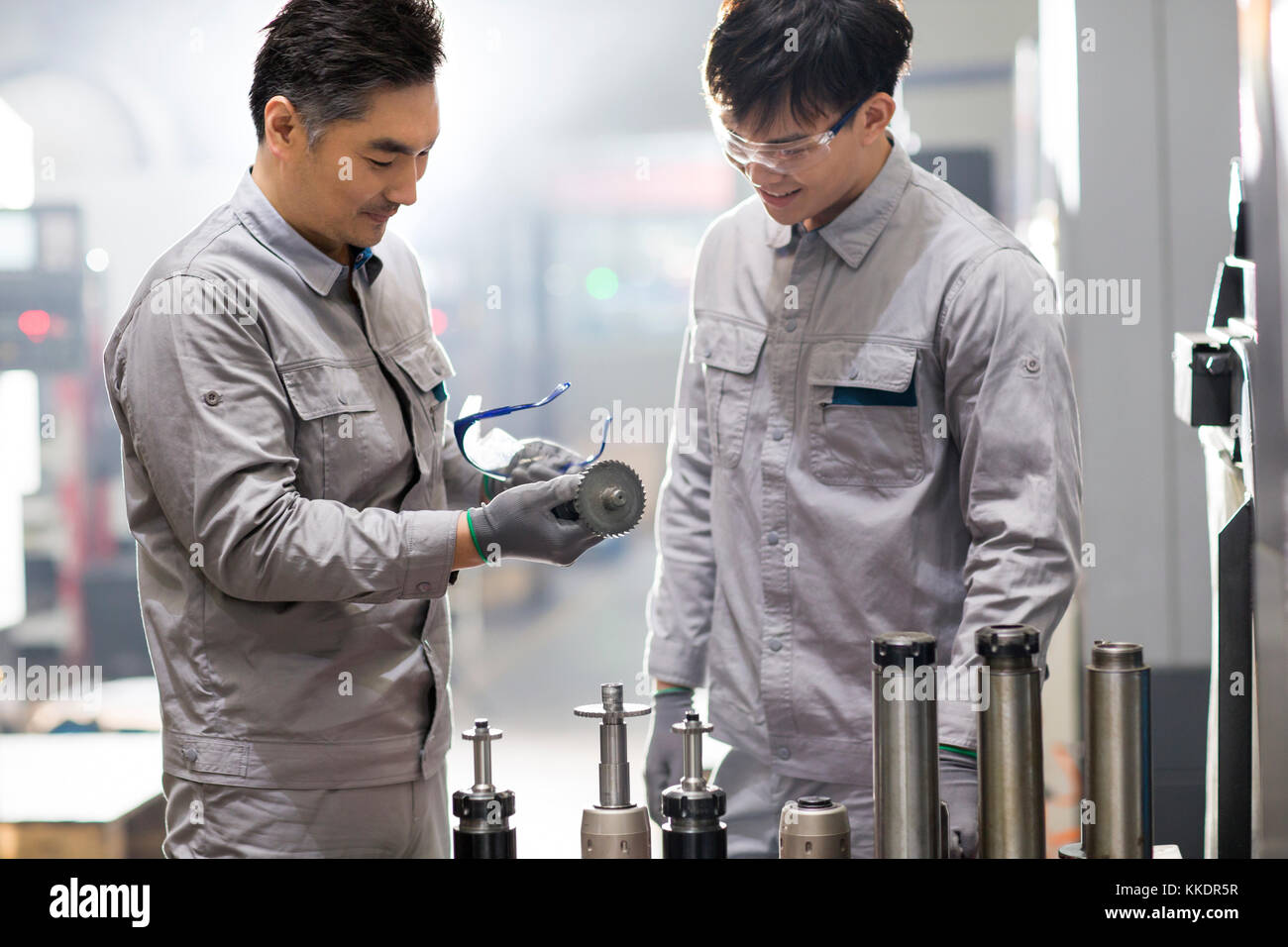 Confident Chinese engineers working in the factory Stock Photo - Alamy