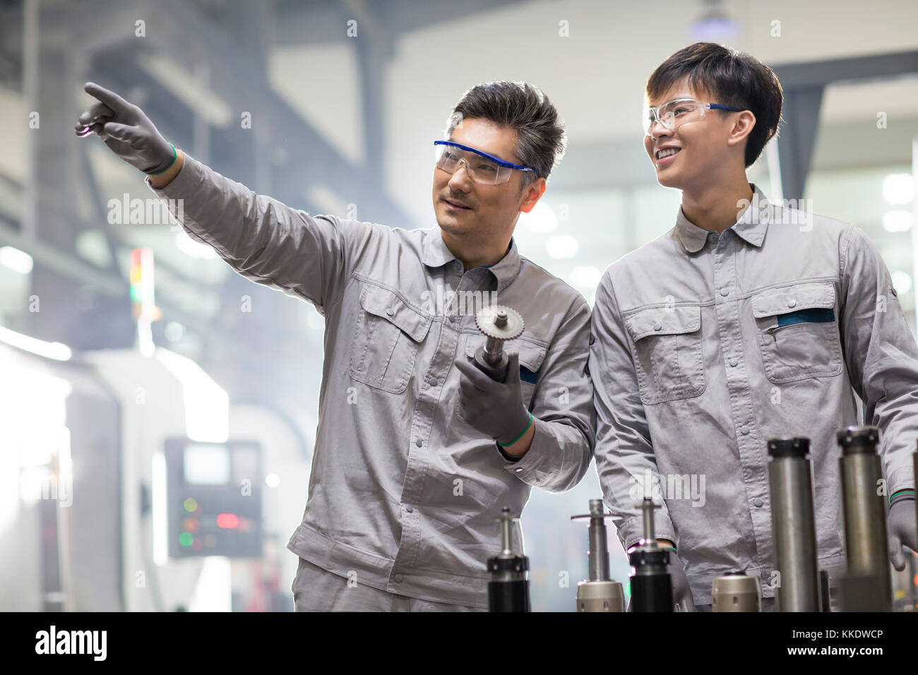 Confident Chinese engineers working in the factory Stock Photo - Alamy