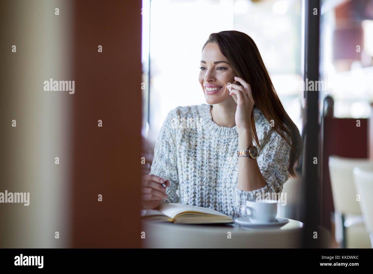 Young beautiful woman making phone call in cafe Stock Photo - Alamy