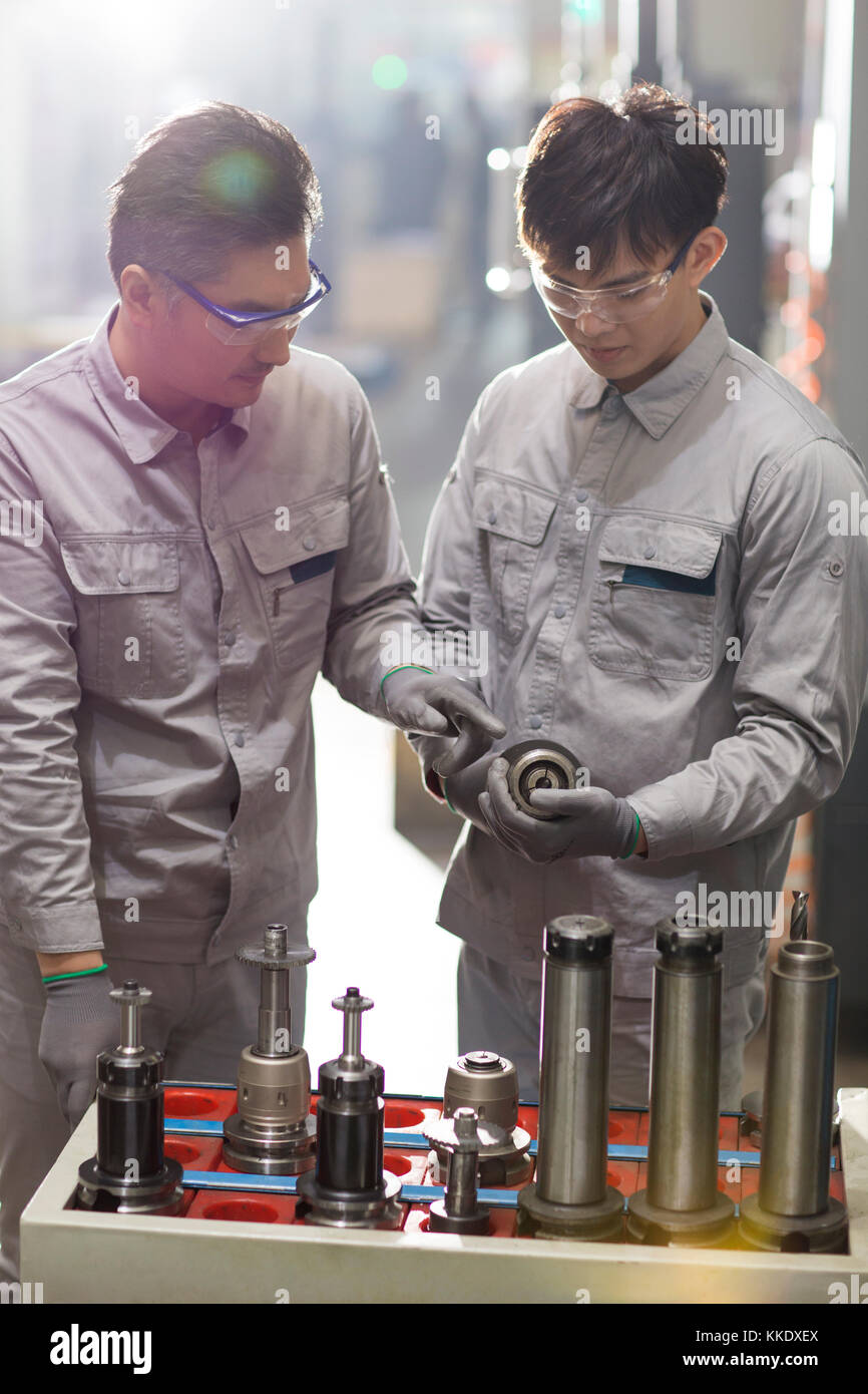 Confident Chinese engineers working in the factory Stock Photo - Alamy