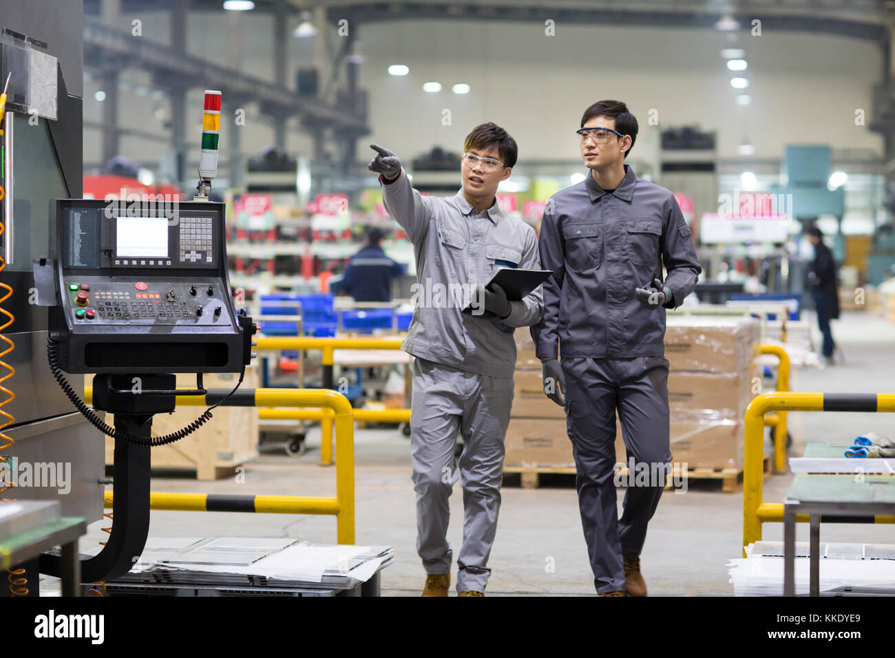 Confident Chinese engineers talking in the factory Stock Photo - Alamy