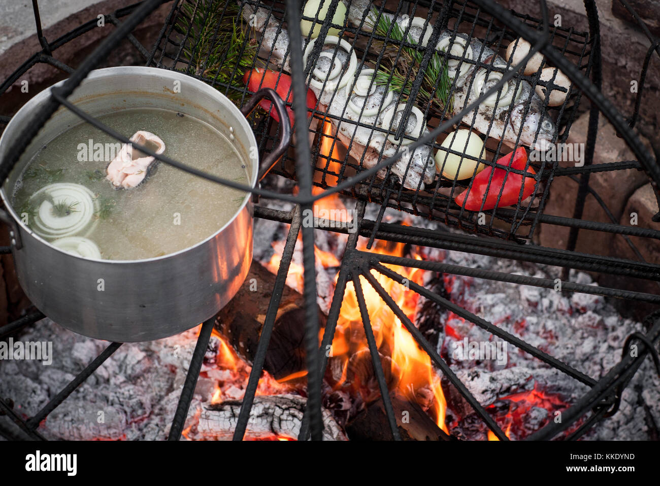 preparation of soup and fish at the stake Stock Photo - Alamy
