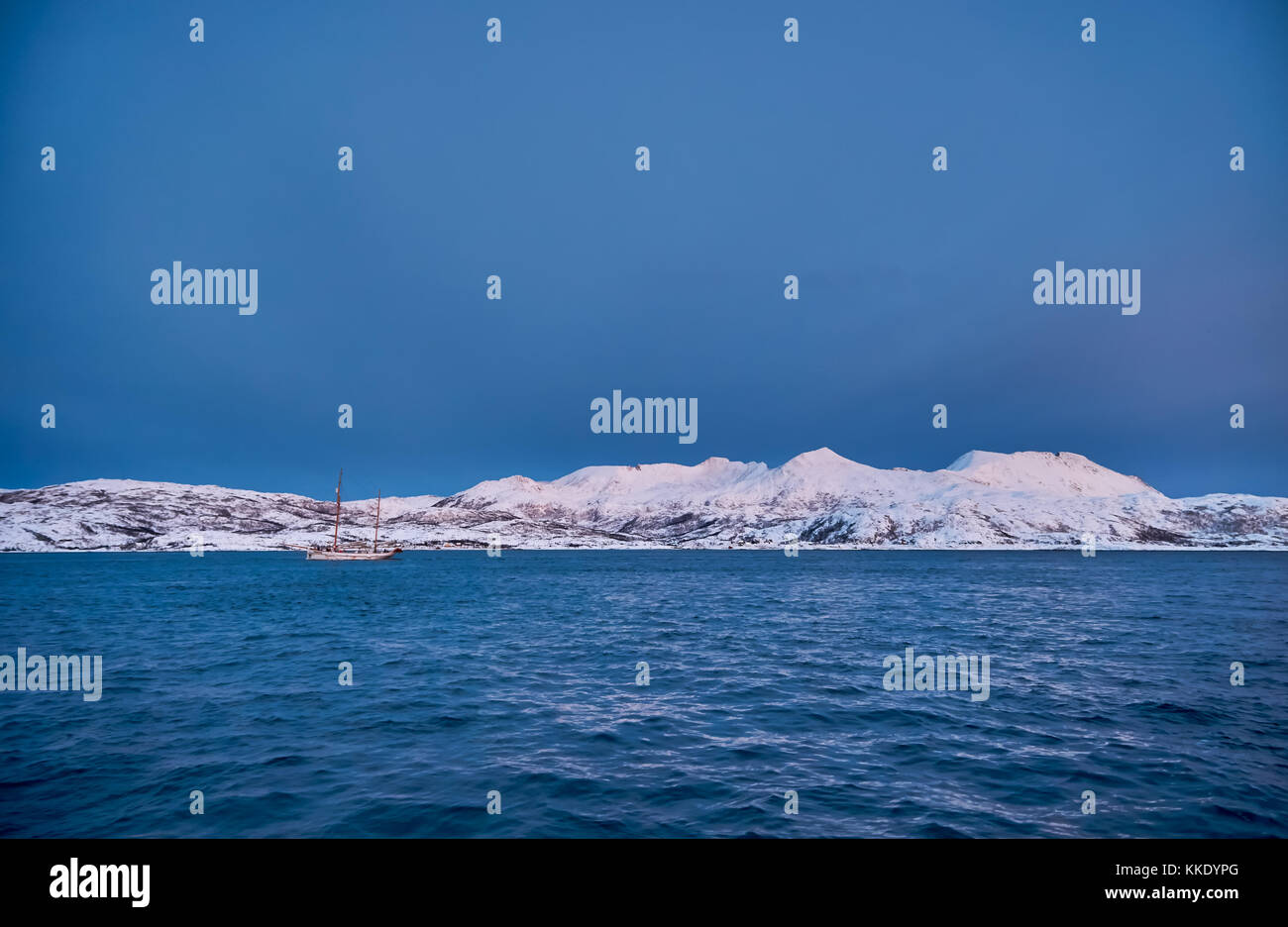 sunrise over fjord with snow covered mountains and winter landscape and ...