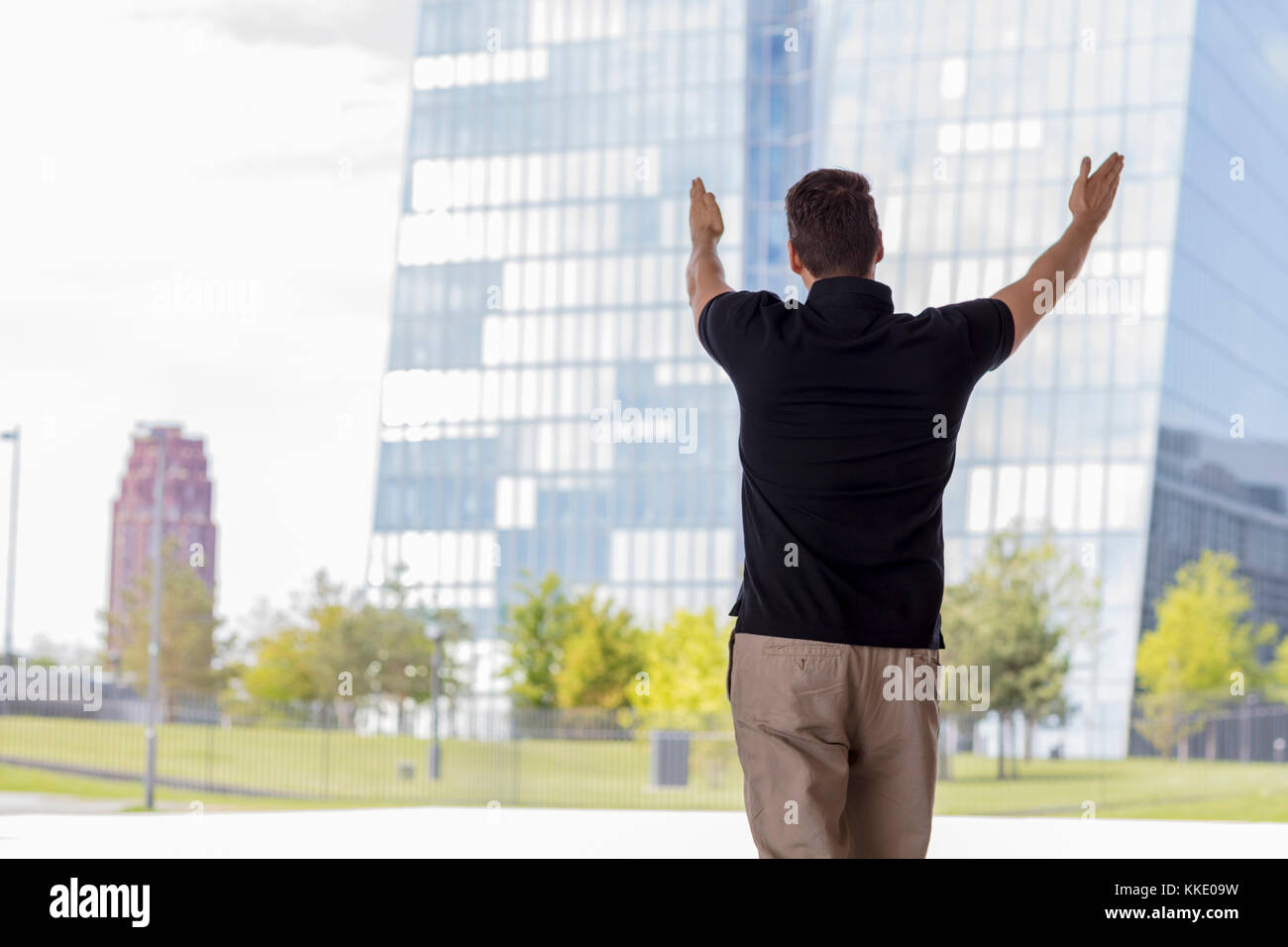 Man pointing towards skyscraper buildings in Frankfurt, Germany. Three ...