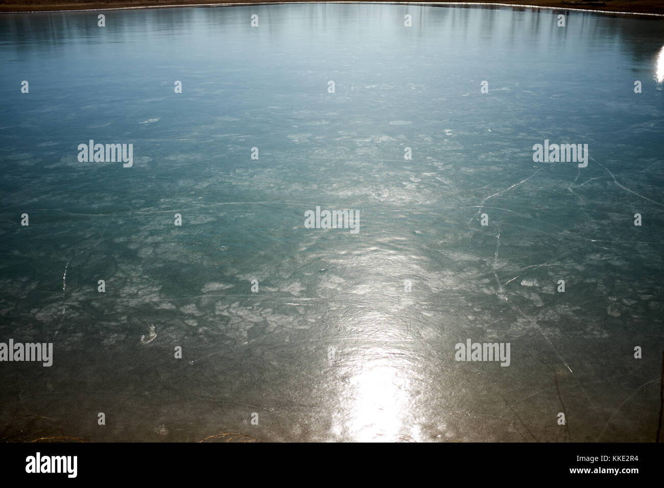 Light illuminating the surface of an ice sheet formed on the top of a ...