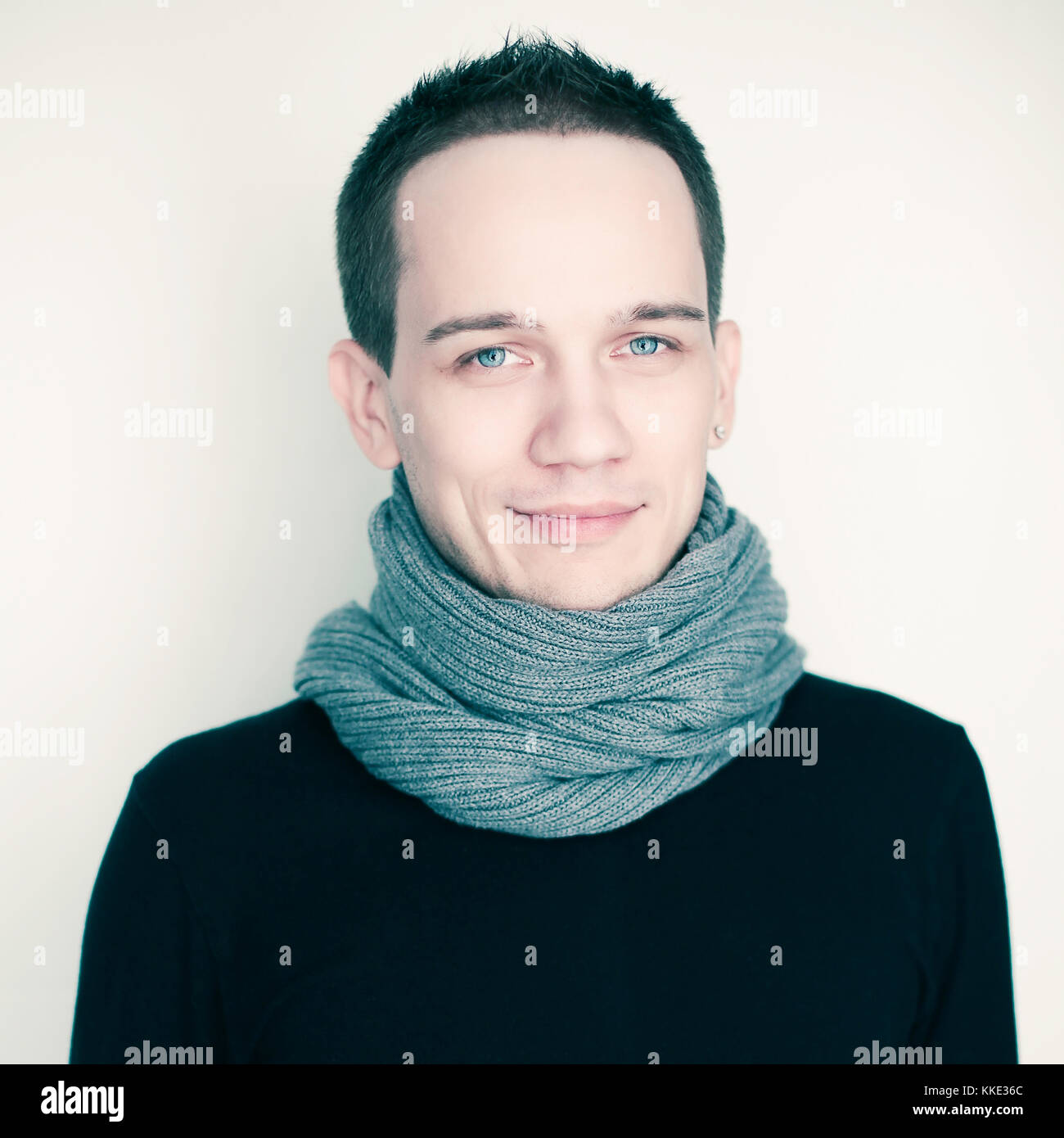 Portrait of a happy fashionable male model in black sweater and gray ...