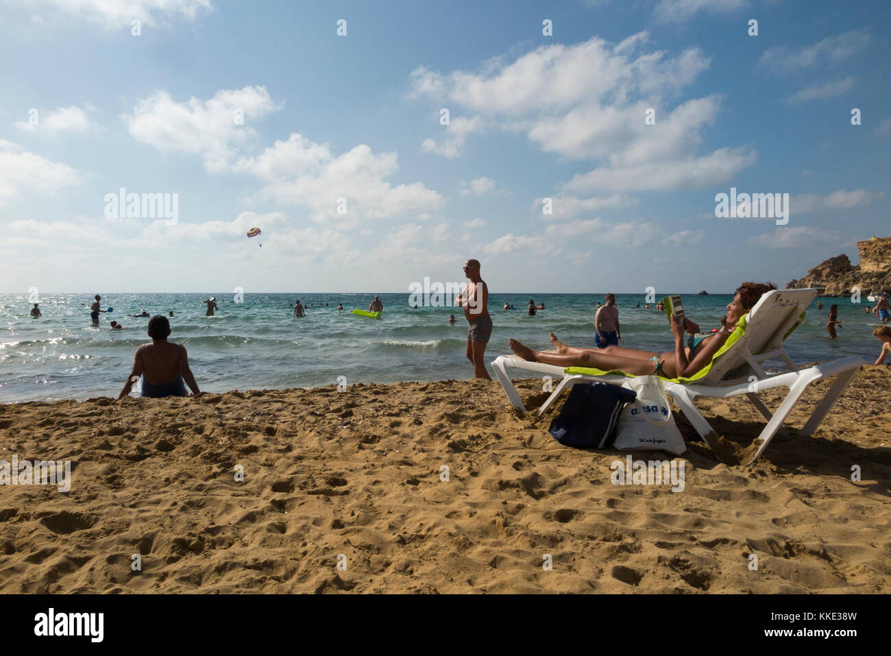Sea and sandy beach with tourists / sunbathers people enjoying ...