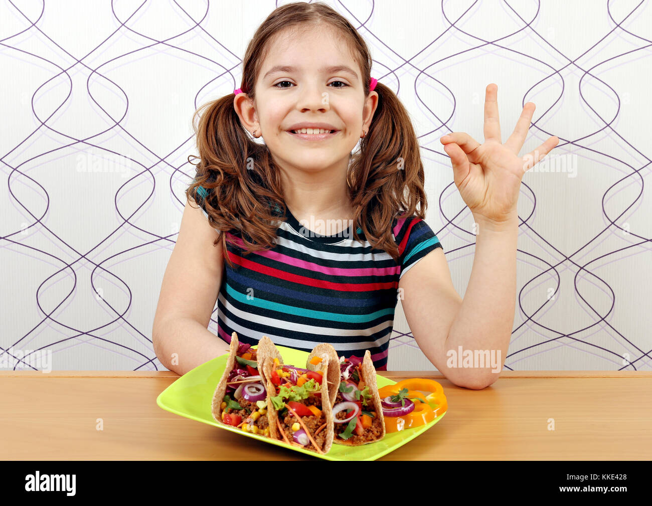 happy little girl with tacos and ok hand sign Stock Photo - Alamy
