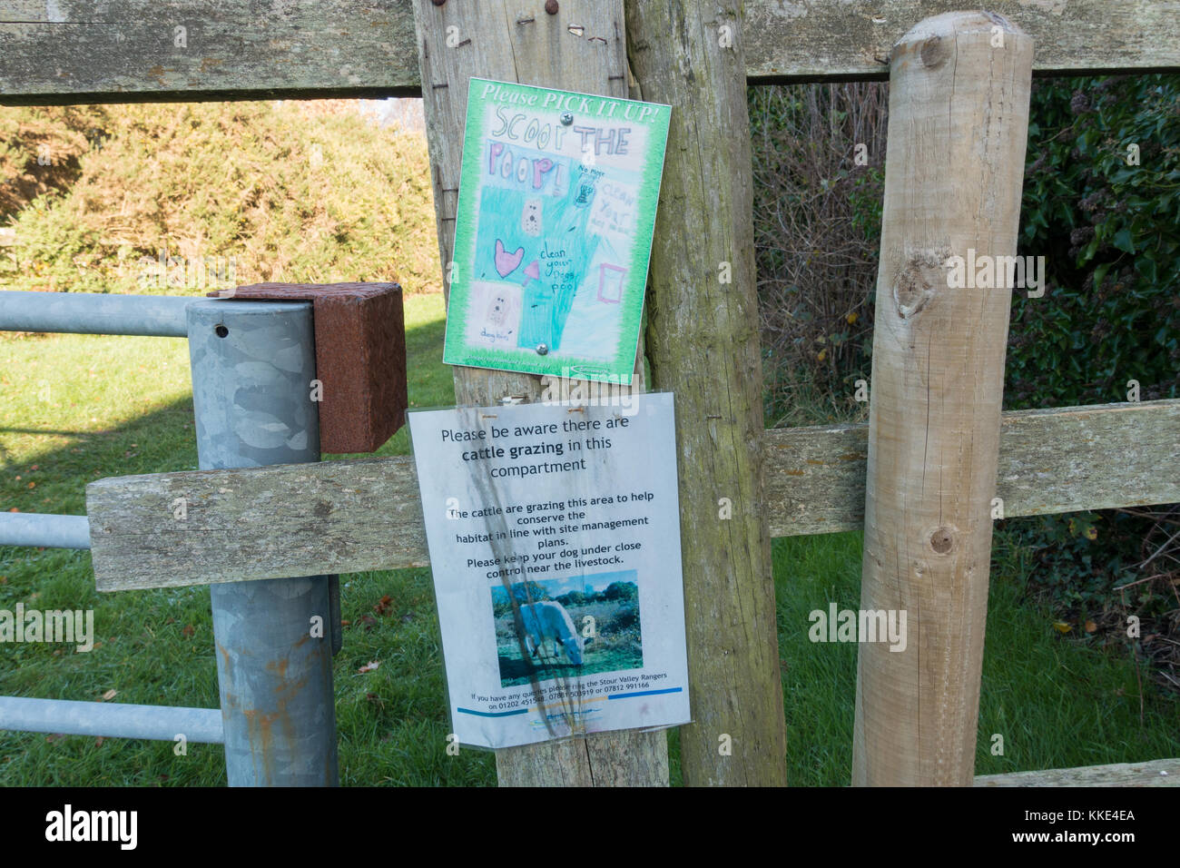 Cattle grazing warning sign & a scoop the poop notice at an entrance to ...