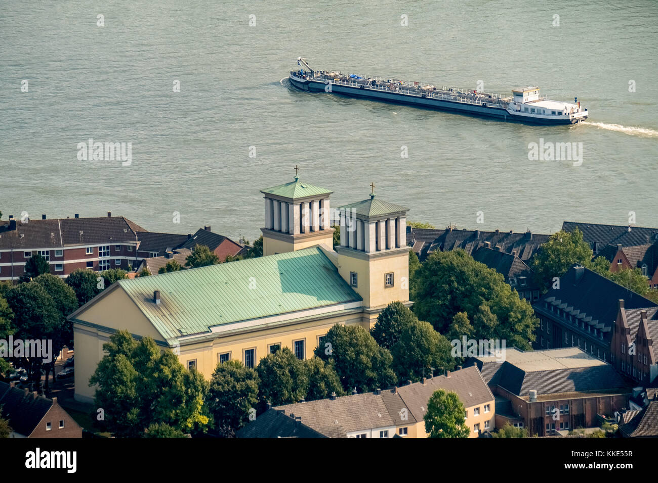 Church of St. Assumption with cargo ship on the Rhine at Rees, Rees ...