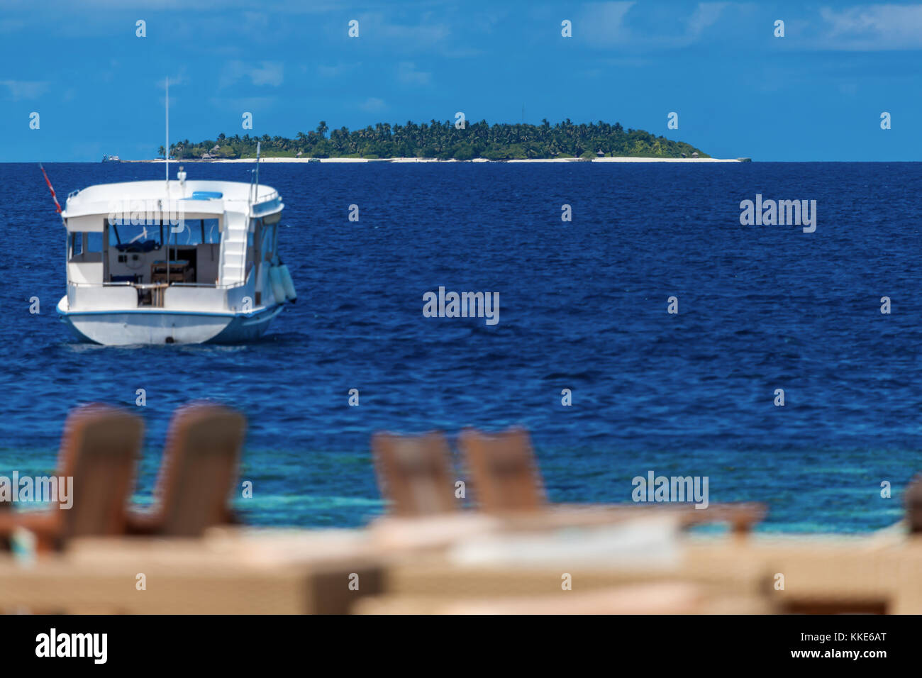 View to another island with a boat Stock Photo - Alamy
