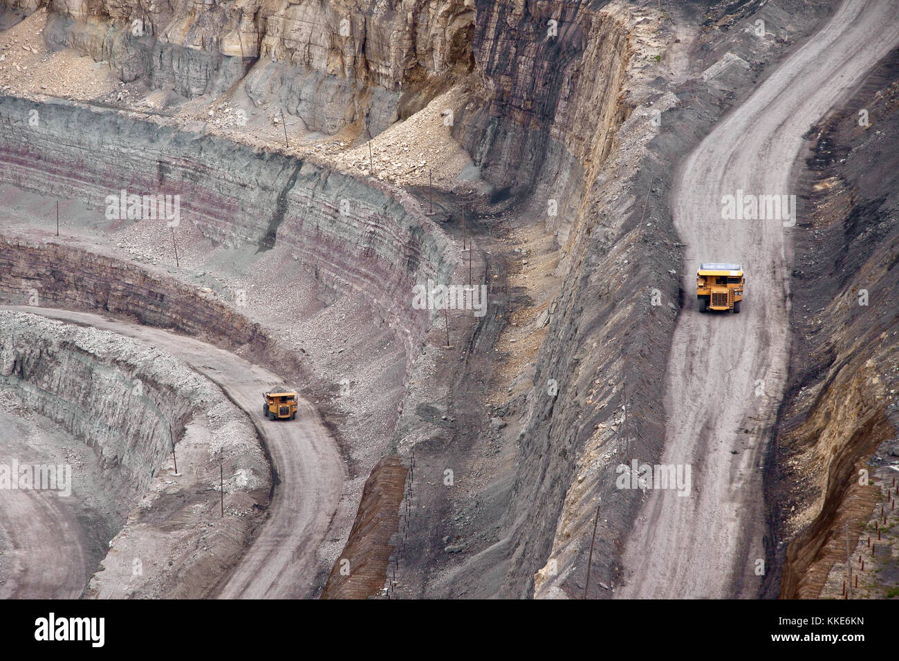 Tip-trucks on the road in open mine Stock Photo - Alamy