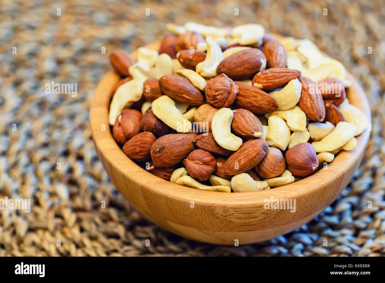 Assorted nuts in wooden bowl Stock Photo - Alamy