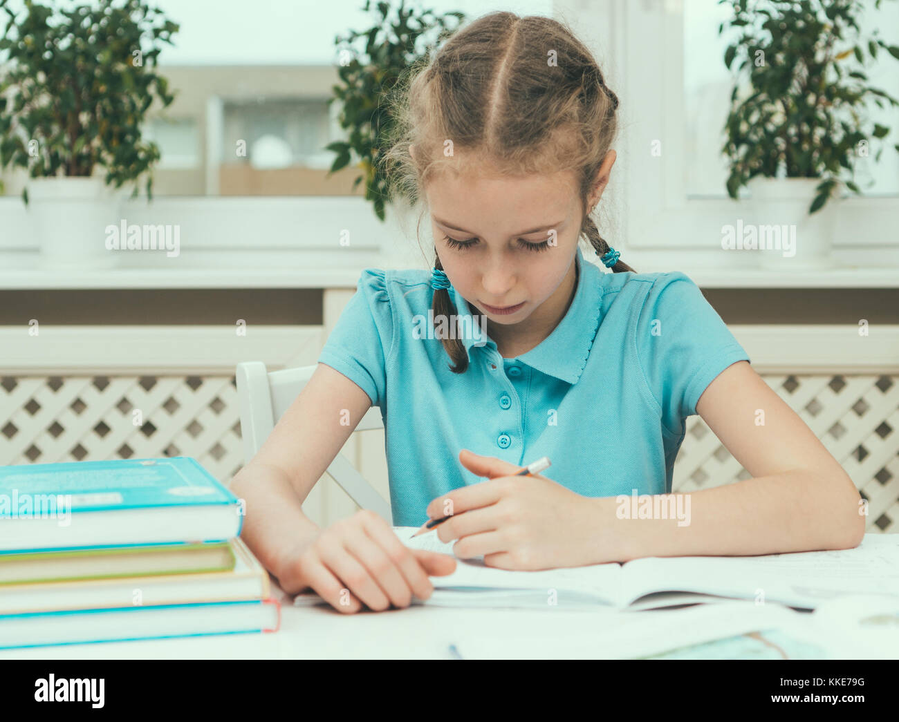 Little girl doing her homework at home Stock Photo - Alamy